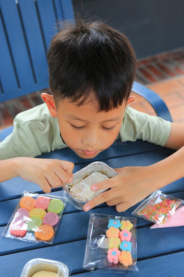 Asian Little Boy Enjoy Baking, Decorating Cupcake with Jelly and Icing ...