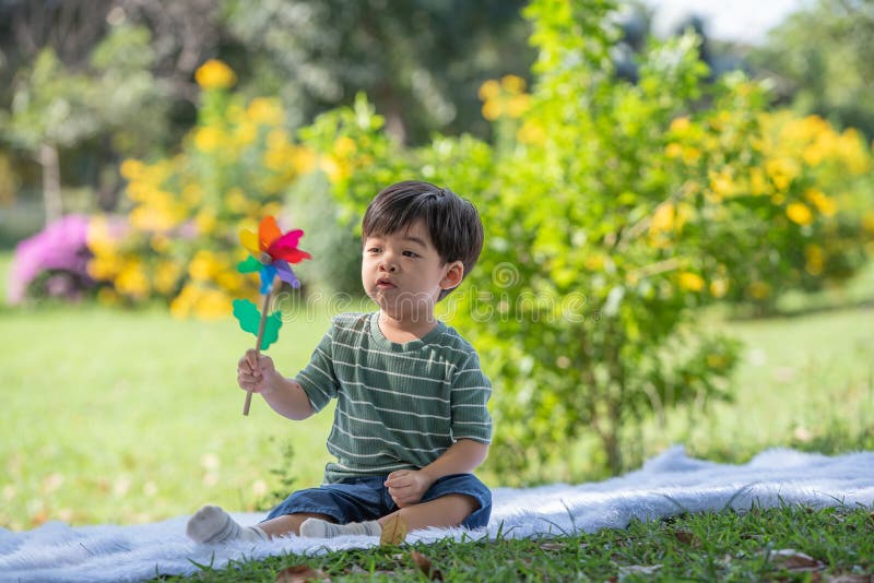 Asian Little Child Having Fun Playing with Windmill in the Park Stock ...