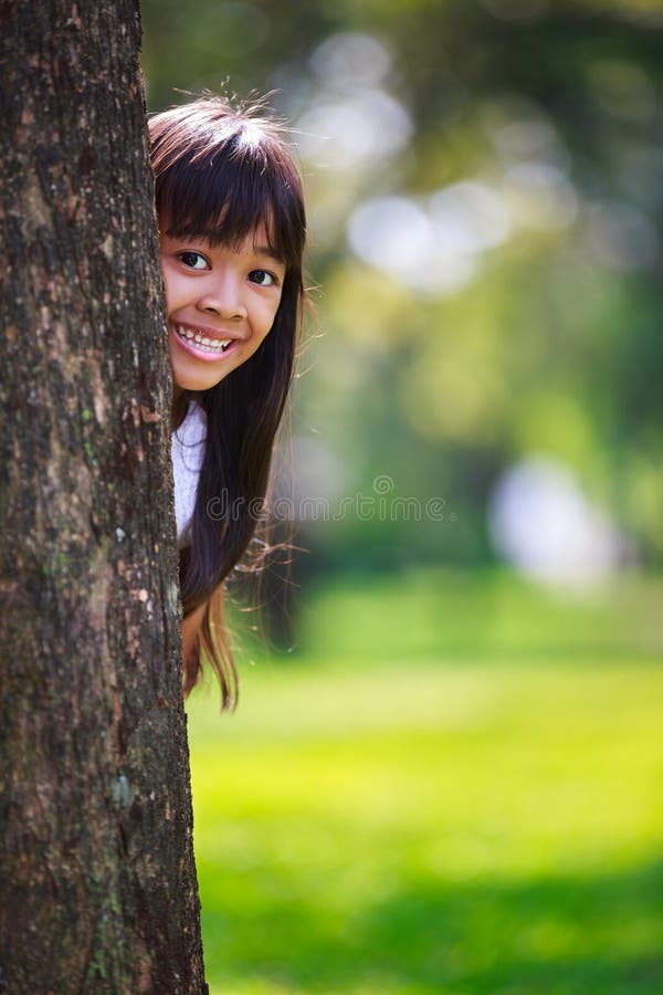 Asian Little Girl Smiling Behind a Tree Stock Image - Image of ...