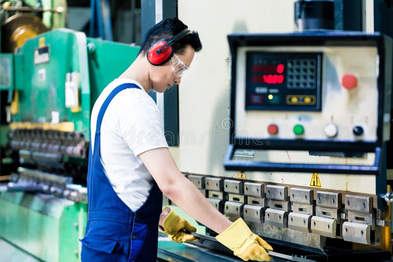 Asian Machine Operator in Production Plant Stock Photo - Image of ...