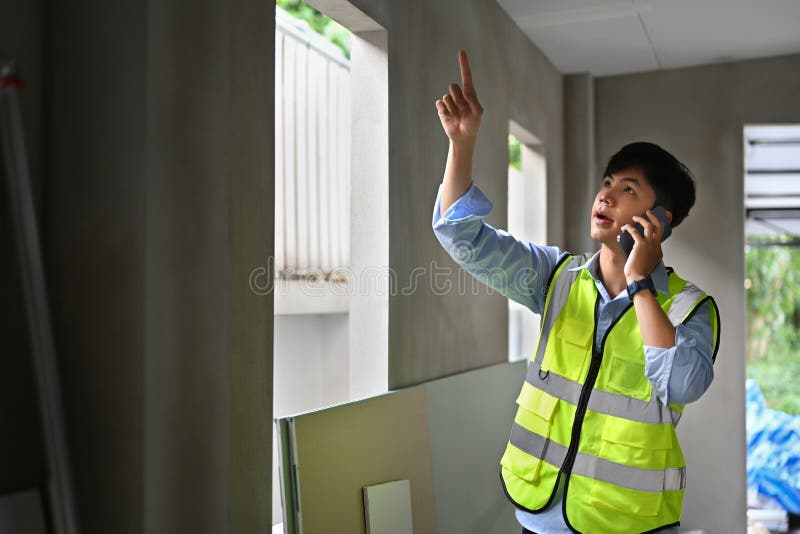 Asian Male Engineer Supervisor Having Phone Conversation while ...