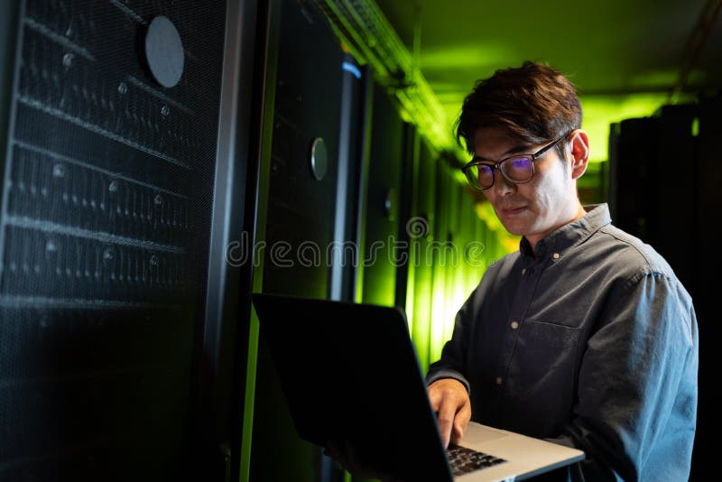Asian Male Engineer Using Laptop in Computer Server Room Stock Photo ...