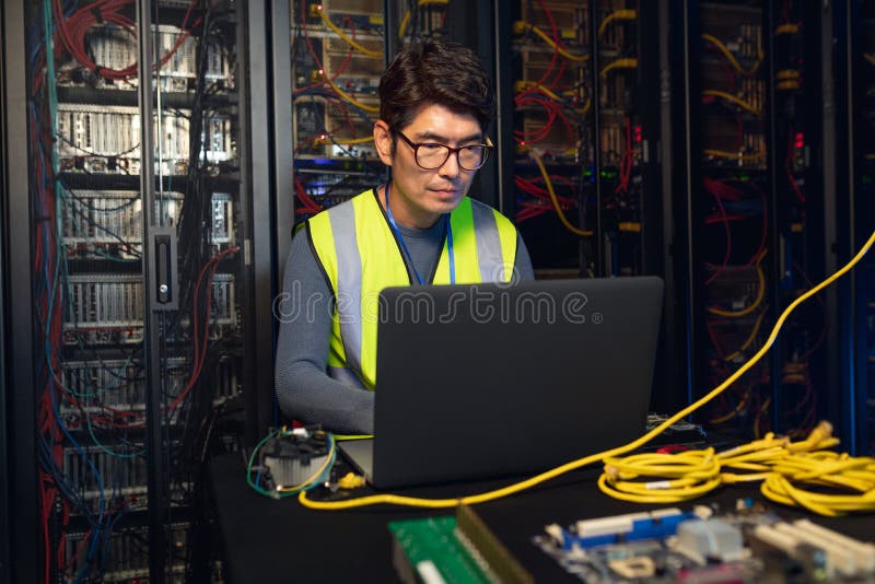 Asian Male Engineer Using a Laptop in Computer Server Room Stock Image ...