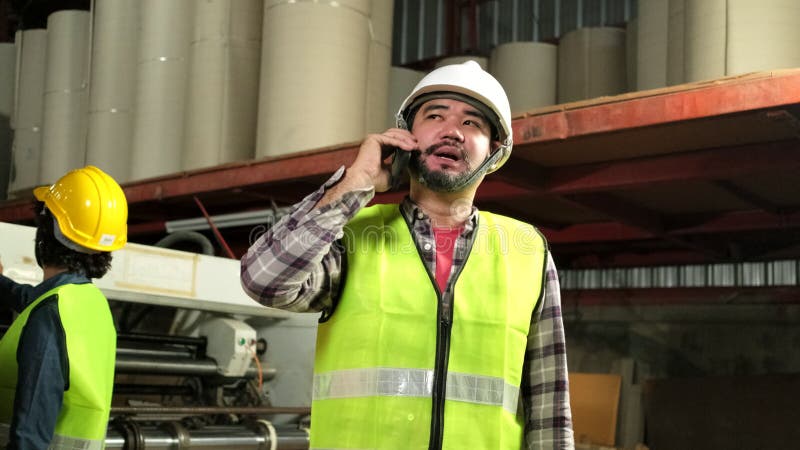 Asian Male Worker, Supervisor Talks with Mobile Phone at Paper Factory ...