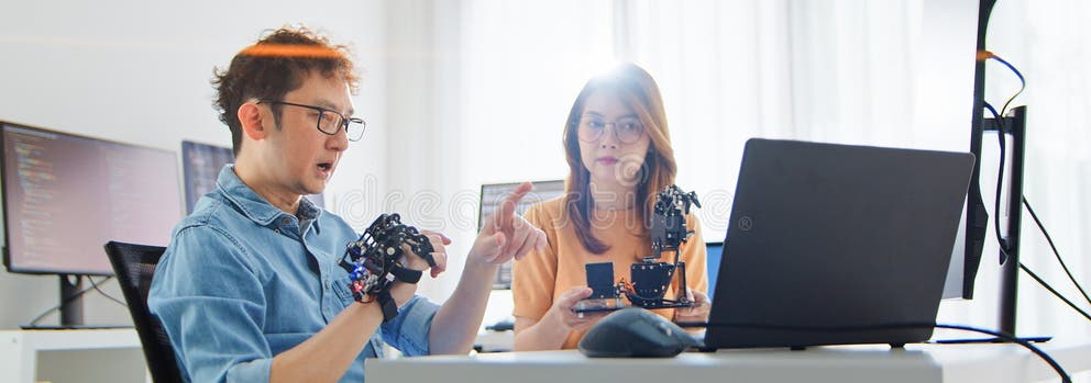 Asian Male, Female Programming Developer Work Together at Home Office, Coding Robotic Arm ...