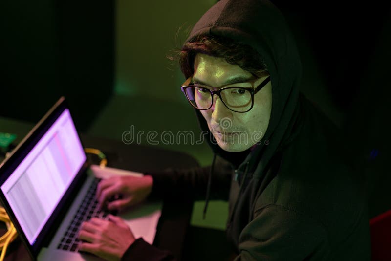 Asian Male Hacker Using a Laptop in Computer Server Room Stock Image ...