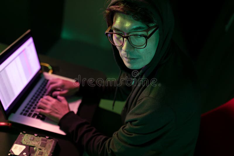 Asian Male Hacker Using a Laptop in Computer Server Room Stock Photo ...