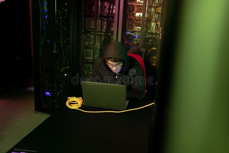Asian Male Hacker Using a Laptop in Computer Server Room Stock Photo ...