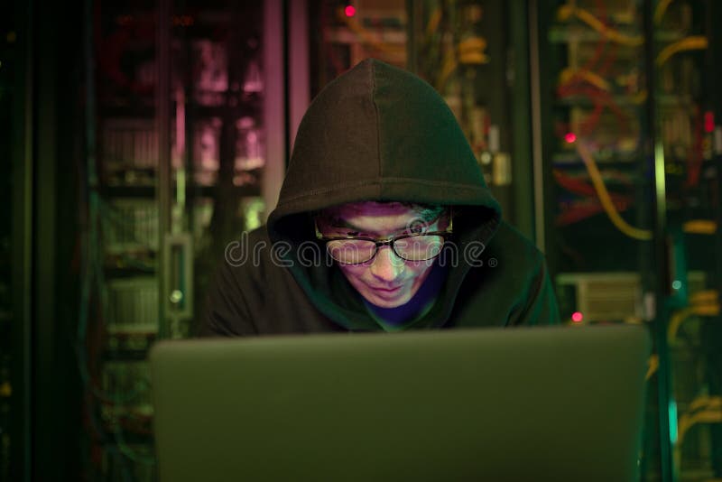 Asian Male Hacker Using a Laptop in Computer Server Room Stock Image ...