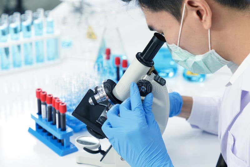 Asian Male Scientist Using Microscope Working in Lab while Checking ...