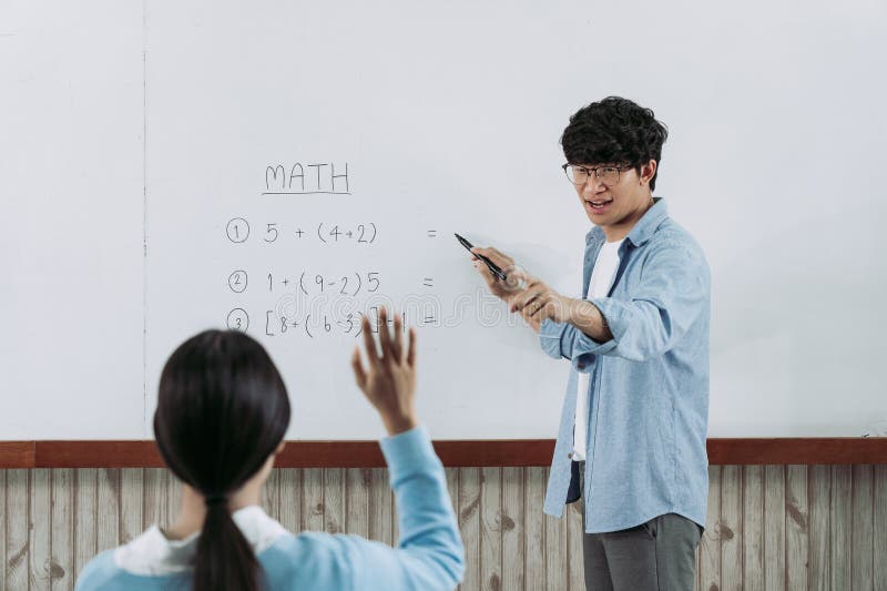 Asian Male Teacher Teaching Students at the Classroom Stock Photo ...