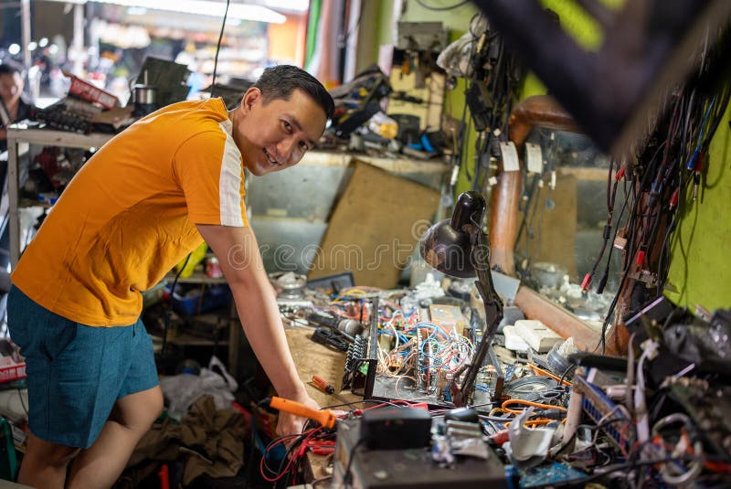 Asian Male Technician Smiles at the Camera at the Service Station Stock ...