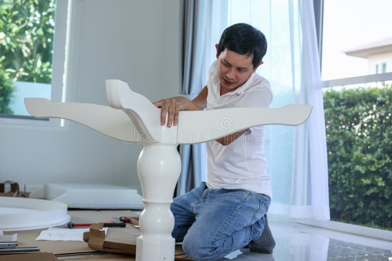 Asian Man Assembling White Table Furniture at Home Stock Image - Image ...