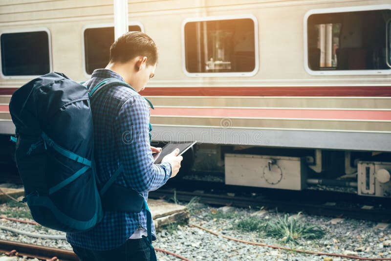 Asian Man Backpack for Travel at Train Station and Using Tablet Stock ...
