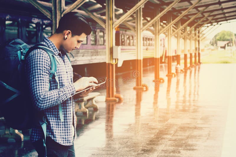 Asian Man Backpack for Travel at Train Station and Using Tablet Stock ...