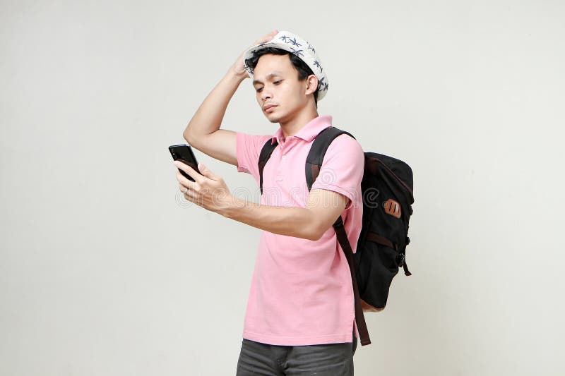 Man Backpacker Hold Mobile Phone and Tumbler Bottle with Confused ... Man Backpacker Hold Mobile Phone and Tumbler Bottle with Confused ...