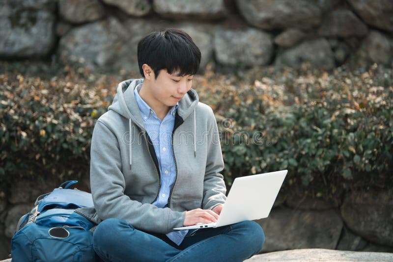 Asian Man Backpacking Using Laptop. Stock Image - Image of people ...