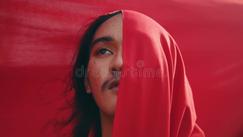 An Asian Man Bound and Strangled by a Red Cloth with a Resigned Face in ...