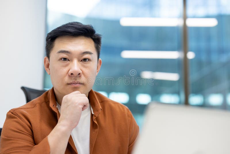 Asian Man Businessman in Modern Office Setting Contemplating Strategy ...