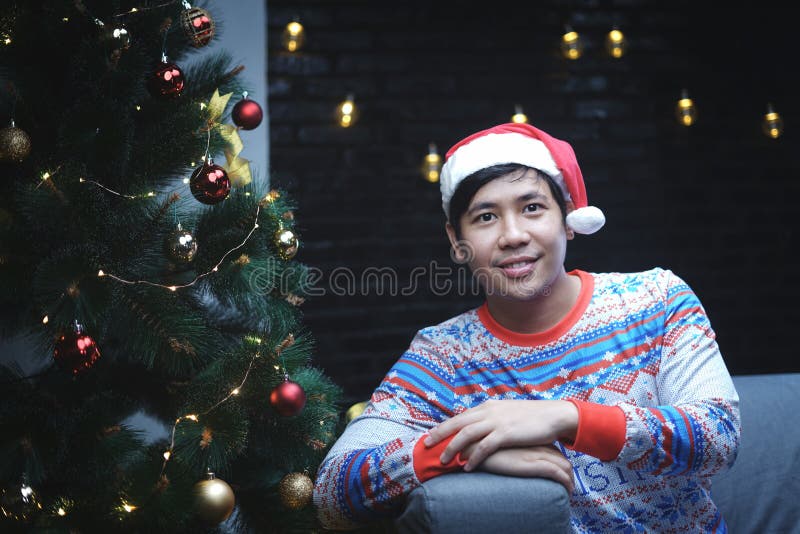 Asian Man with Christmas Costume Sitting beside Christmas Tree Stock ...