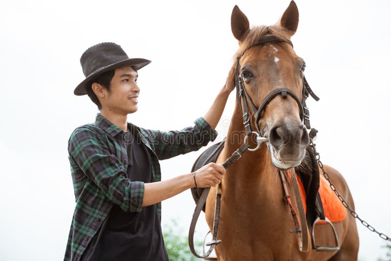 Asian Man in Cowboy Hat Stroking Horse Head Stock Photo - Image of ...