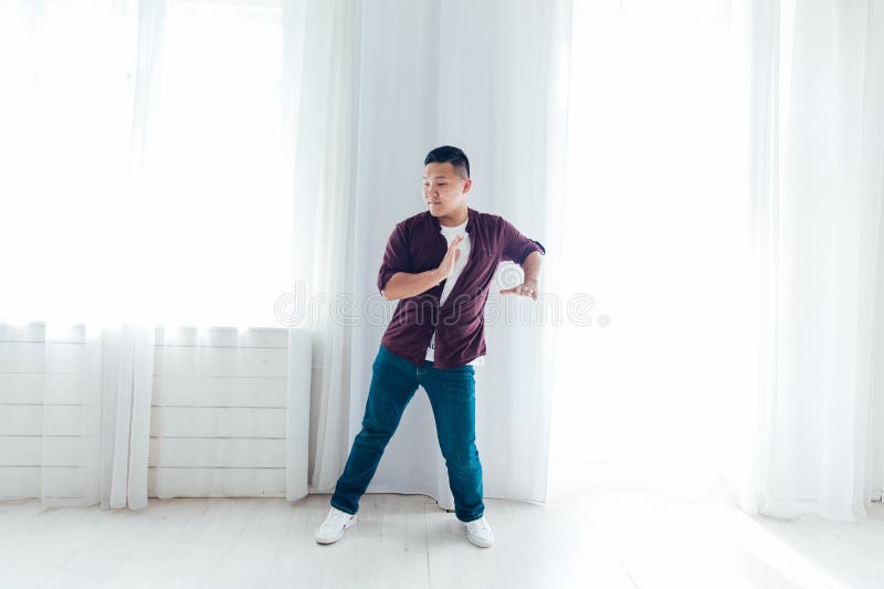 Asian Man Dancing To Music Alone in White Room Stock Image - Image of ...