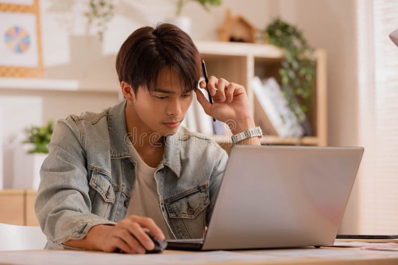 Asian Man Designer Sitting and Thinking about Design in the Morning at ...