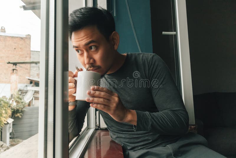Man is Drinking Hot Coffee and Feeling Relax by the Windows Stock Image ...