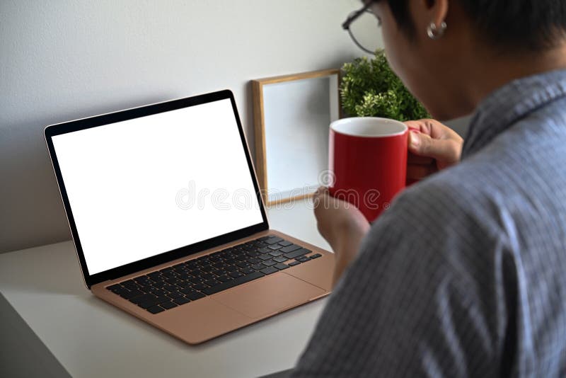 Man Drinking Hot Coffee and Using Laptop Computer at Home. Stock Image ...