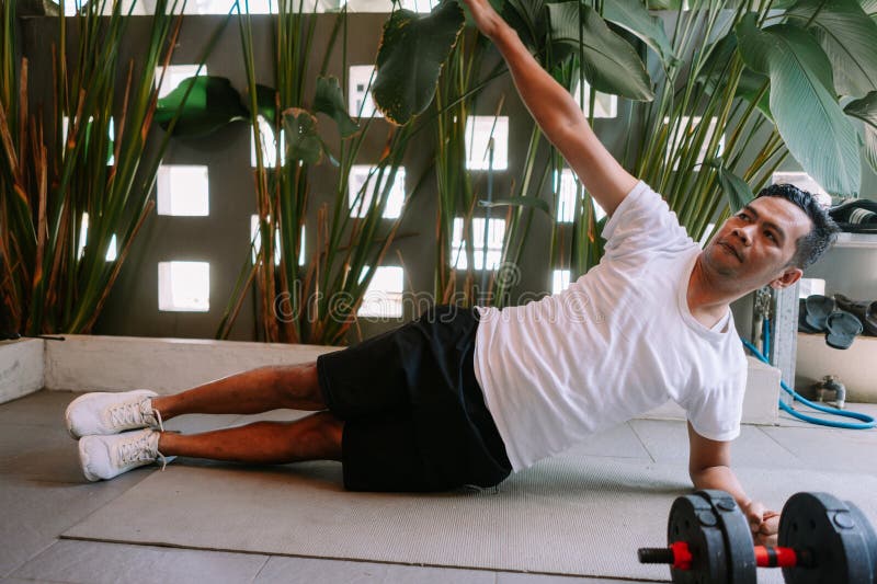 Asian Man Exercising Side Plank at Home for Strength Training Routine ...