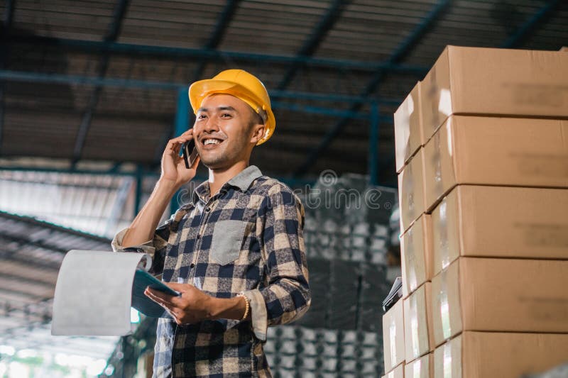 Asian Man Factory Worker Makes Cell Phone Call while Working Stock ...