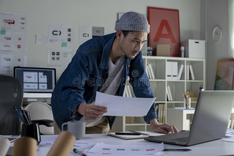 Asian Man Graphic Designer Working in Office. Artist Creative Designer ... Asian Man Graphic Designer Working in Office. Artist Creative Designer ...