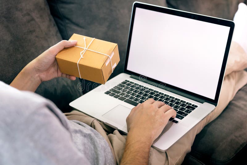 Asian Man Hold a Delivery Box for Shipping and are Using a Laptop Blank ...