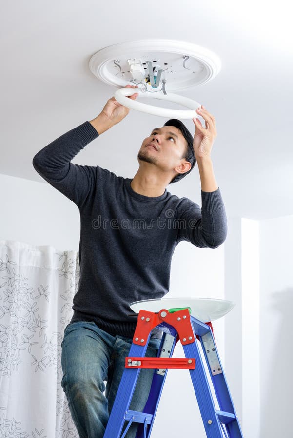 Installing light bulb stock photo. Image of asian, labor - 167103190