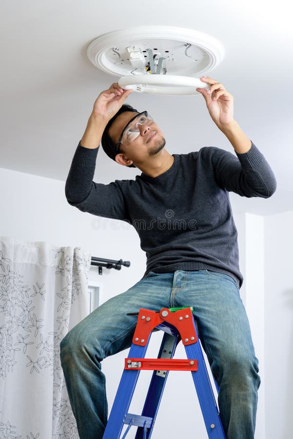 Installing light bulb stock photo. Image of electrician - 167103092