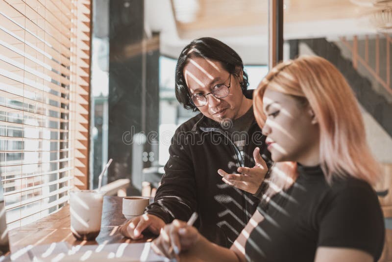 An Asian Man Instructs an Intern on Some Tasks at the Office. Typical ...