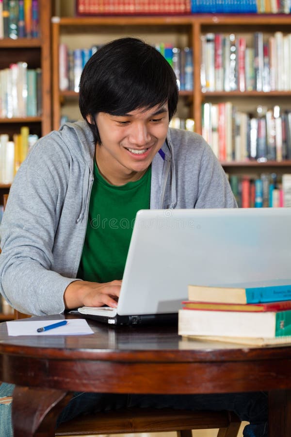 Male Student with Laptop Studying in the University Library Stock Photo ...