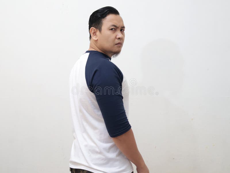 Asian Man Looking Back Over His Shoulder with Suspicious Unhappy ...