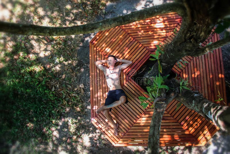 Asian Man Lying on the Outdoor Seating Under the Tree during Summer ...