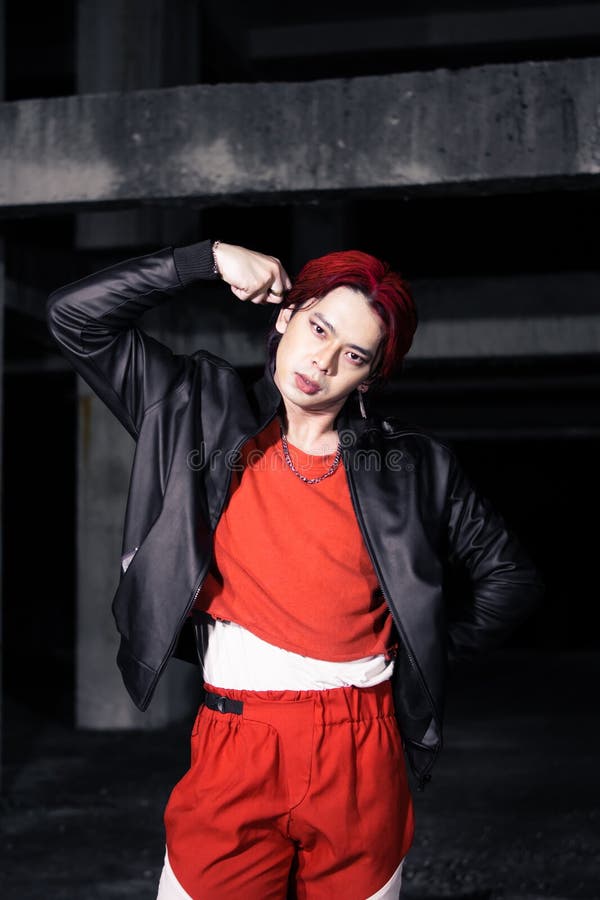 An Asian Man in a Red Shirt and Black Jacket Posing with His Hands ...