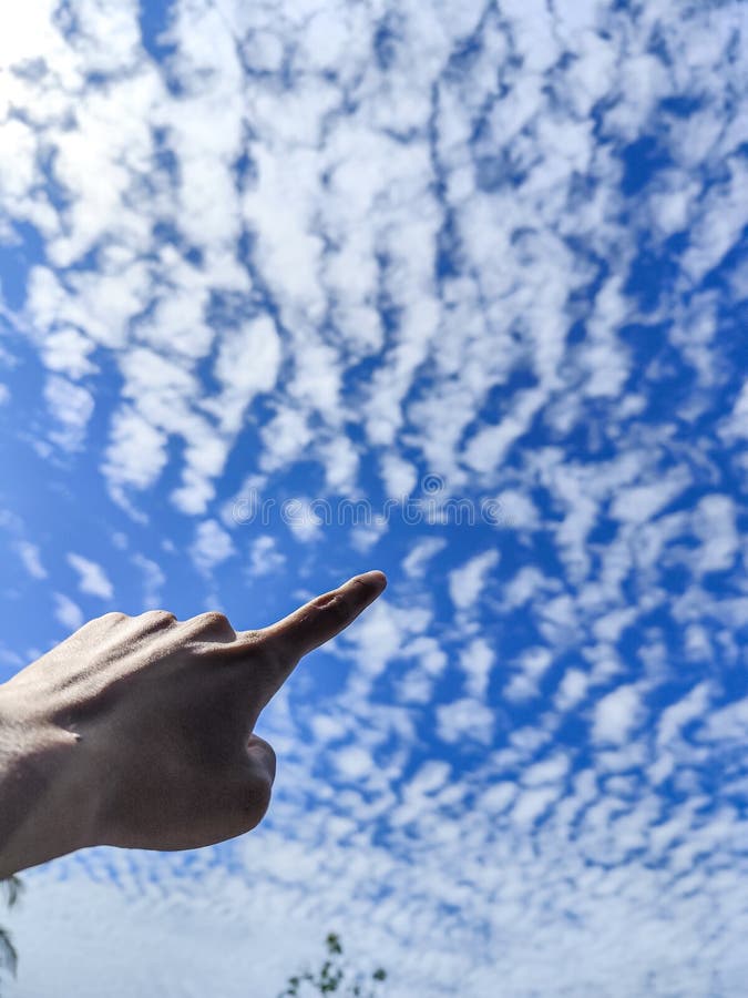 Asian Man& X27;s Hand with Index Finger Points To the Withe Cloud on Blue Sky. Beautiful Texture ...