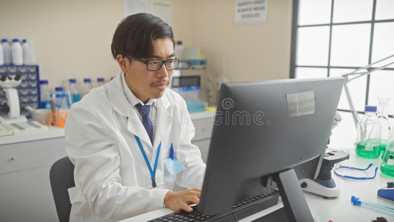 Asian Man Scientist Working at Computer in Modern Laboratory Indoor ...