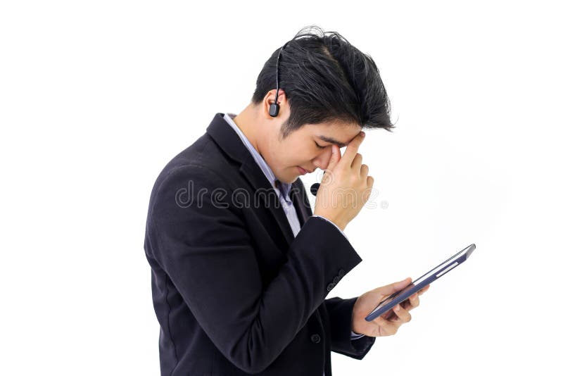 Asian Man Serious Call Center Operator in Wireless Headset Talking with ...