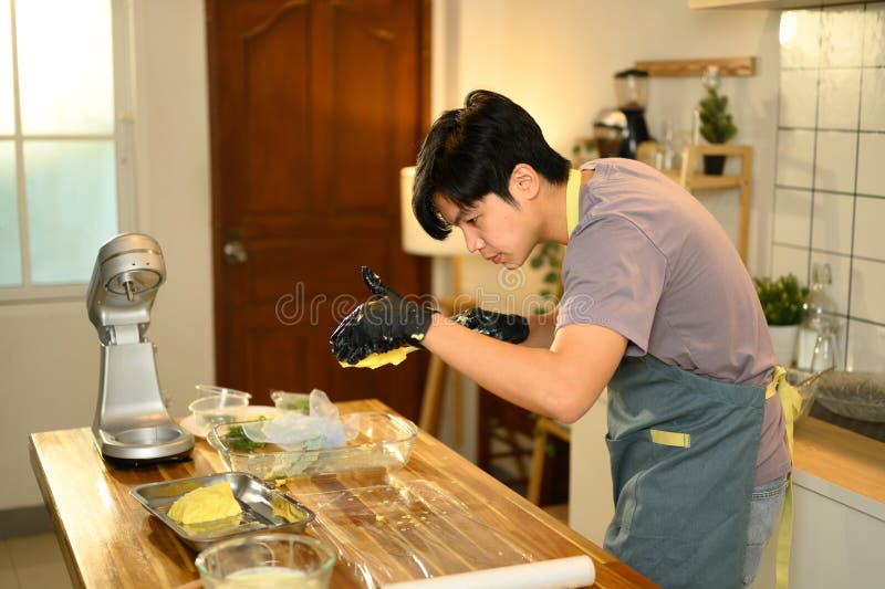 Asian Man Shaping Compound Butter by Hand in a Cozy Kitchen Stock Image ...