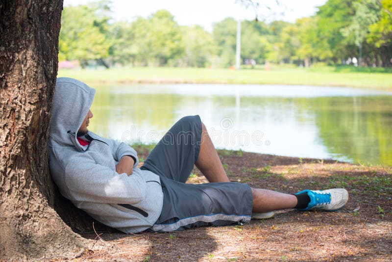 Asian Man Sleeping Under a Tree after Exercise Stock Image - Image of ...