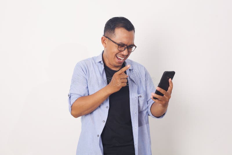 Asian Man Smiling and Pointing Finger To Mobile Phone Screen Stock ...