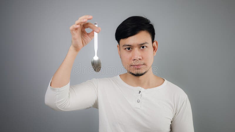 An Asian man with spoon. stock photo. Image of young - 57157634