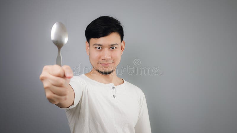 An Asian man with spoon. stock photo. Image of young - 57157634