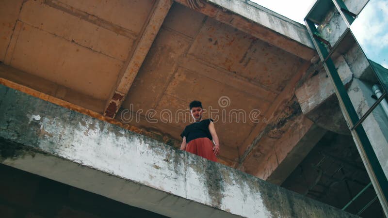 Man Standing on the Edge of Rooftop Unfinished Building with Dramatic ...