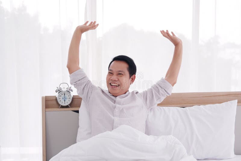 Asian Man is Stretching Lazily after Waking Up on Bed in Bedroom Stock ...